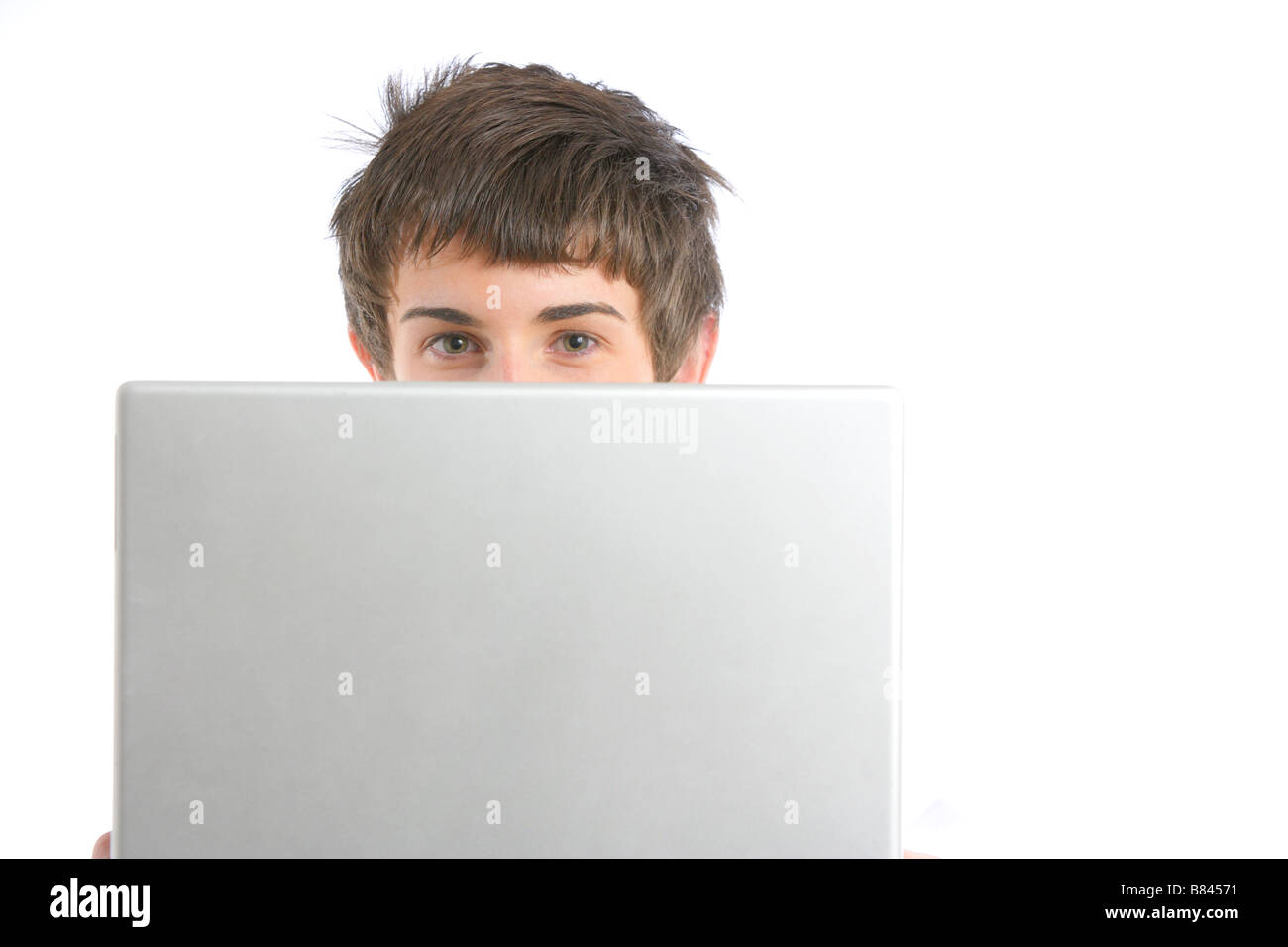 A business man peeking over a modern laptop in the studio Stock Photo ...