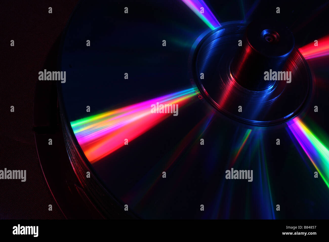 stack of CD's on a spindle lit with red and blue studio lighting Stock ...
