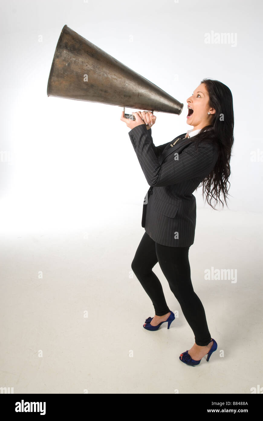 businesswoman shouting down loud hailer Stock Photo - Alamy