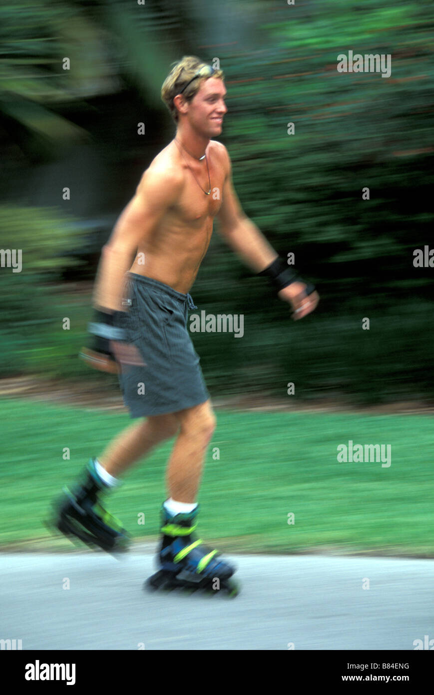 Young Shirtless Man Rollerblading Stock Photo - Alamy