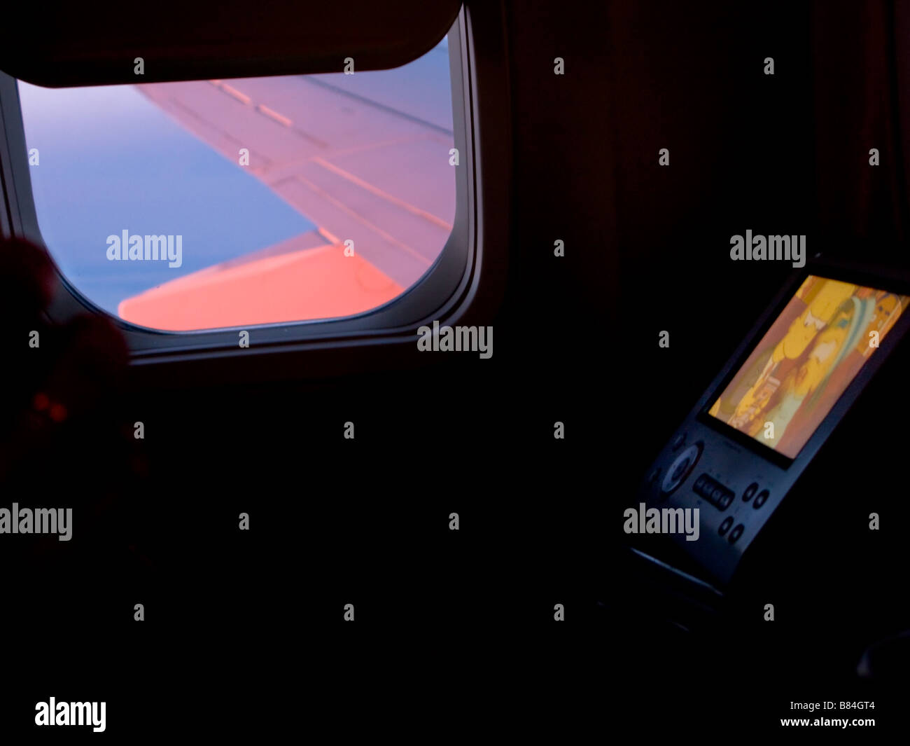 Jet window and digital video player inside Alaska Airlines Boeing ...