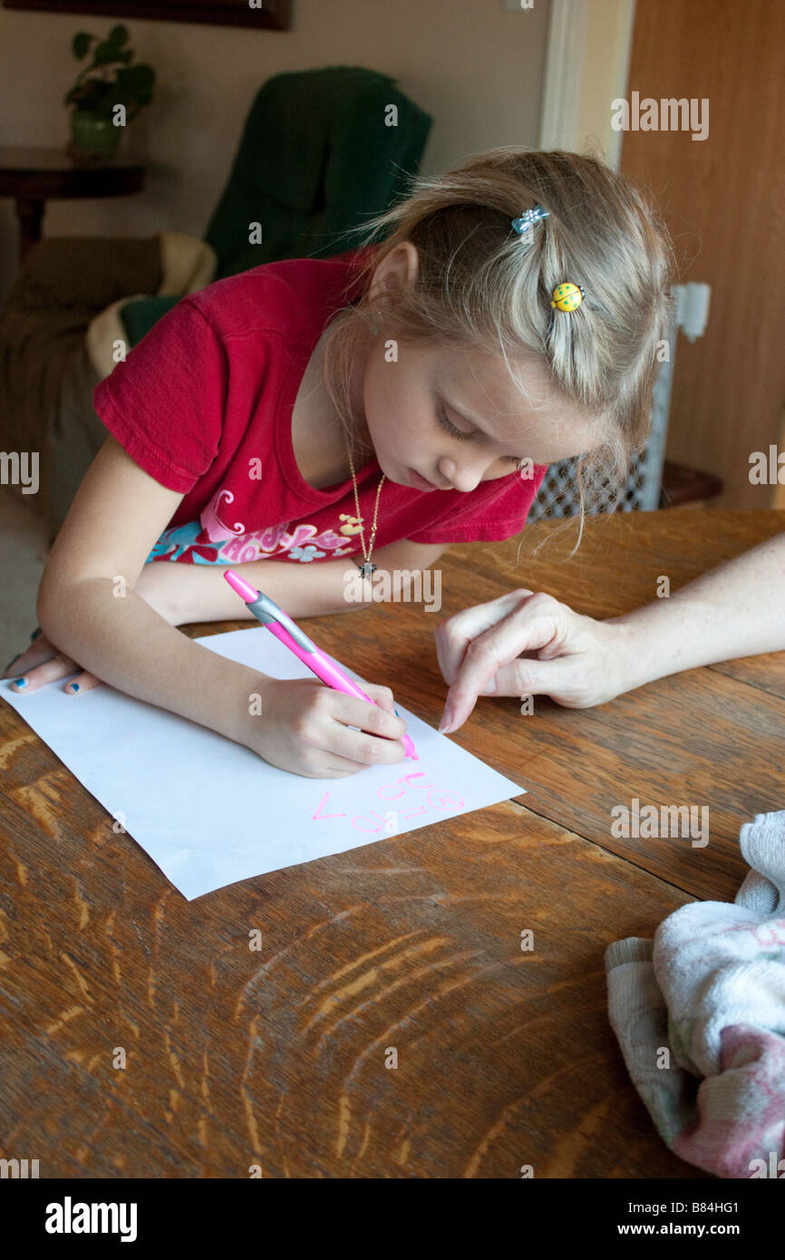 Young girl practicing math skills at Grandma's house Stock Photo - Alamy