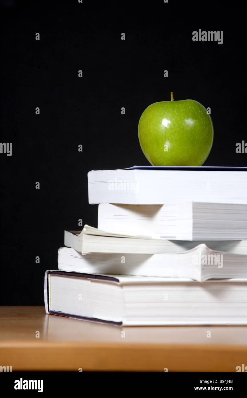 An apple on top of a stack of books Stock Photo - Alamy