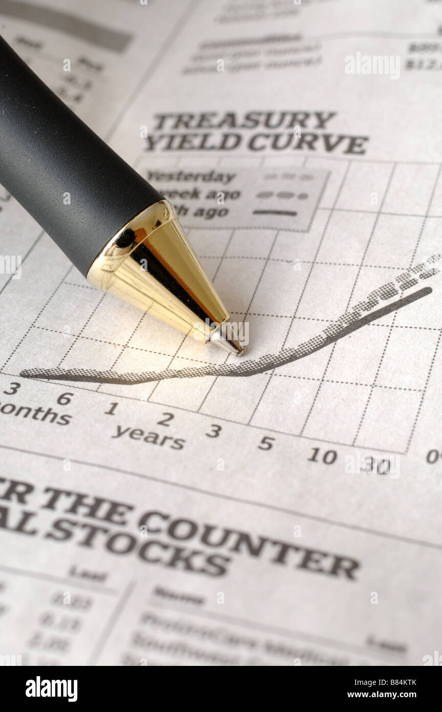 Pen pointing at a financial chart in newspaper Stock Photo - Alamy