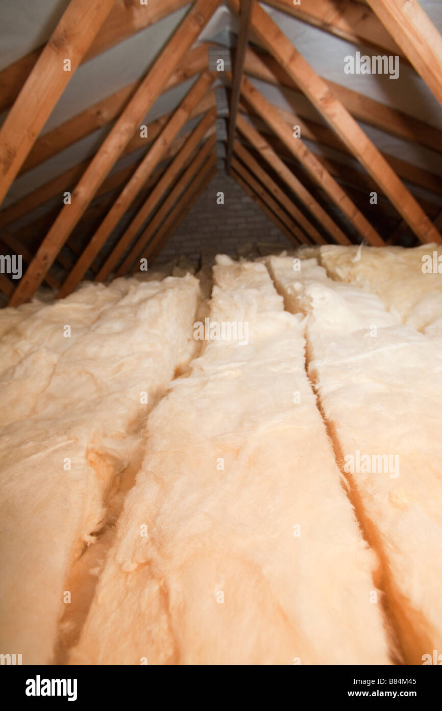 Loft insulation to cut down heat loss in a house loft Stock Photo - Alamy