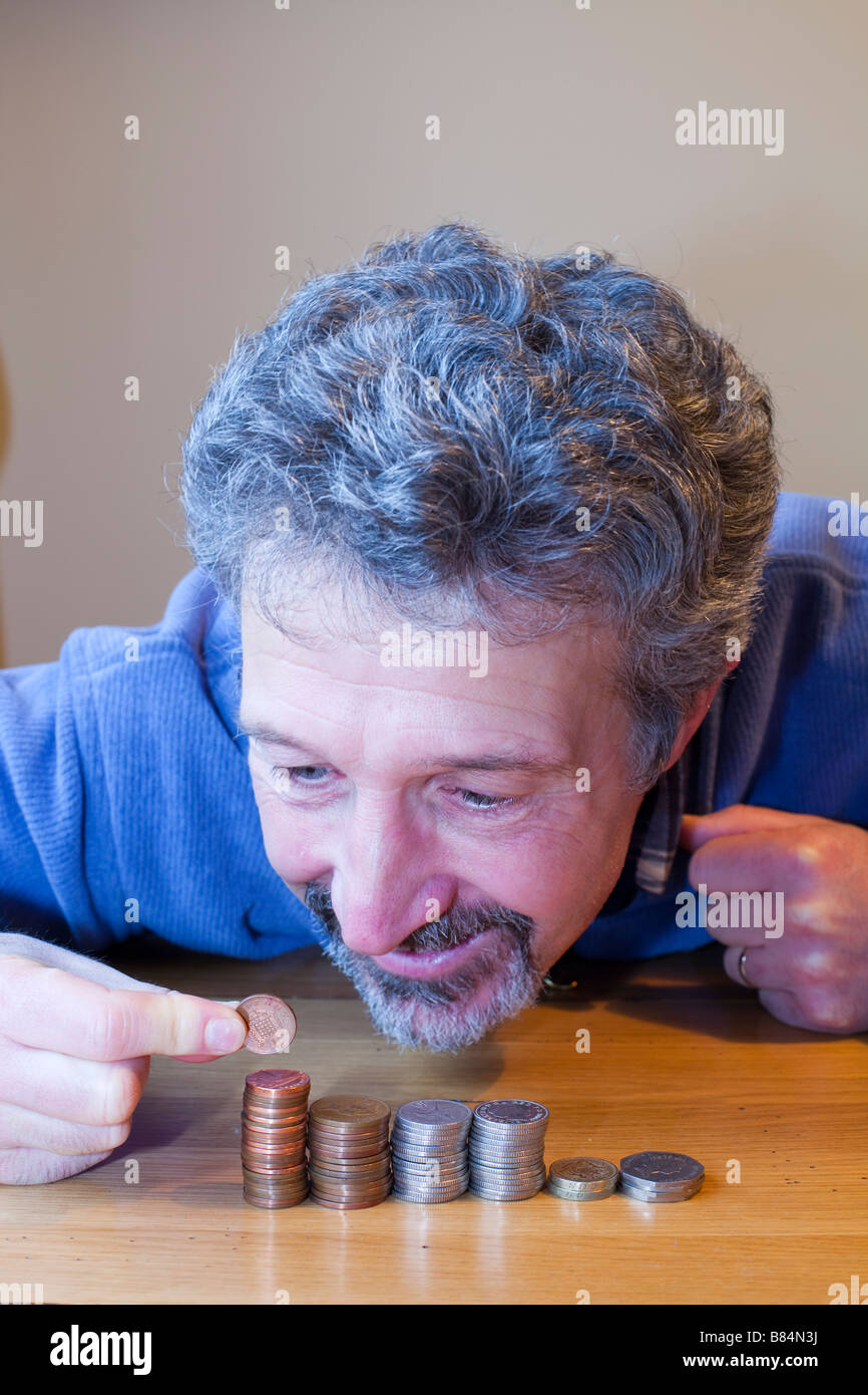 A miserly man counting his money Stock Photo - Alamy