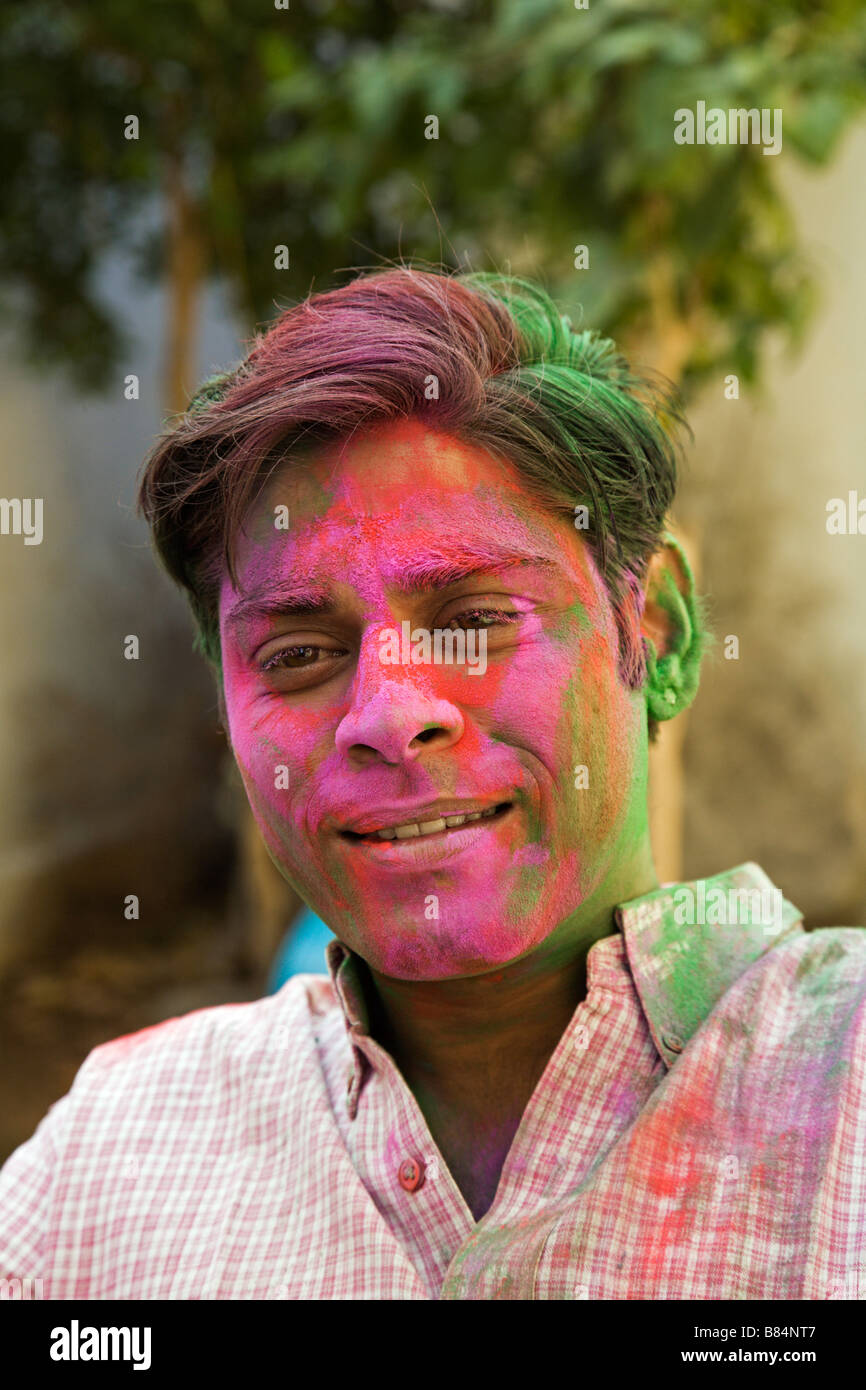 Man with his face covered in coloured powder during the Holi festival ...