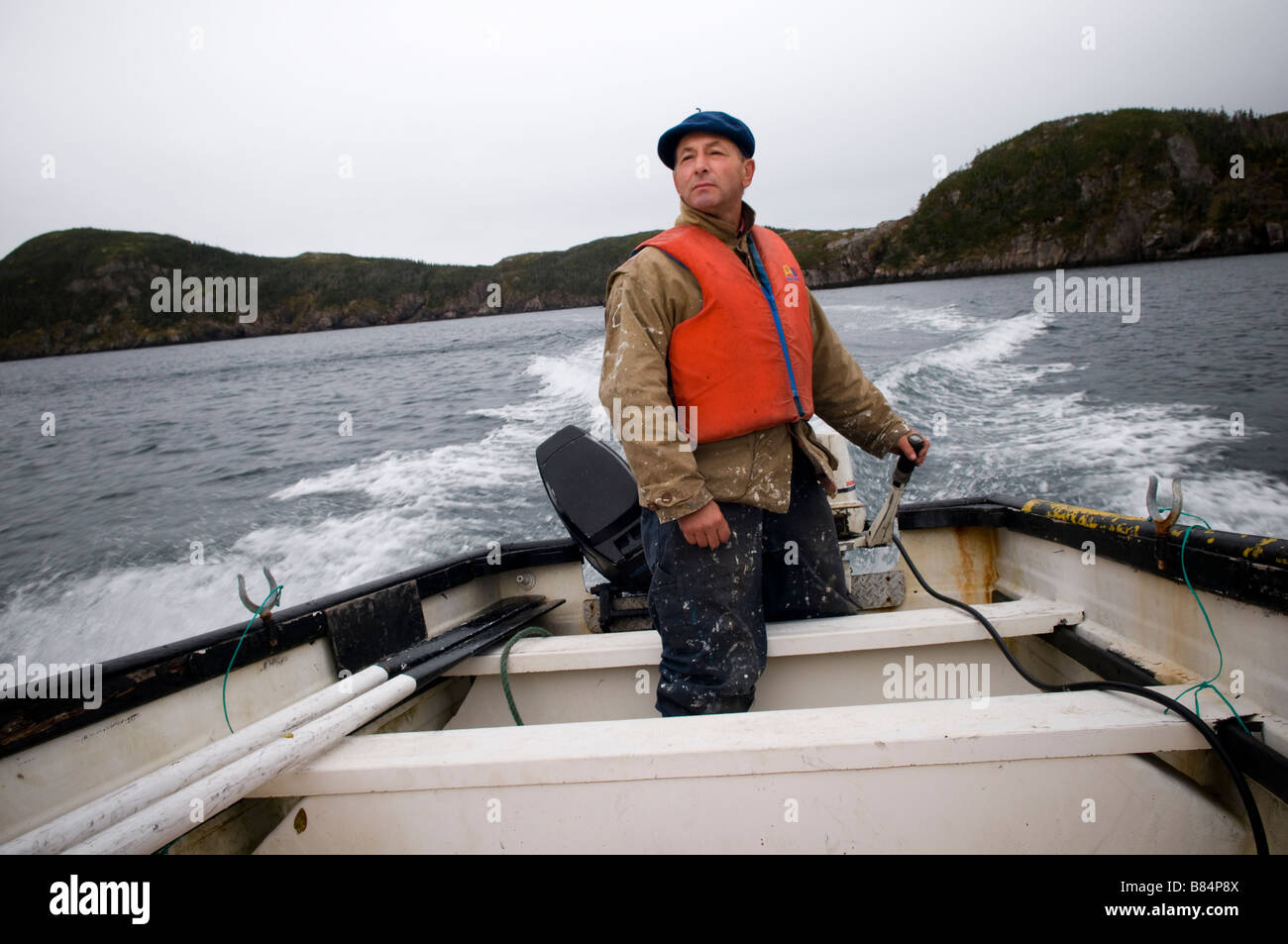 A man navigates his boat through the waters near his home in Burgeo ...