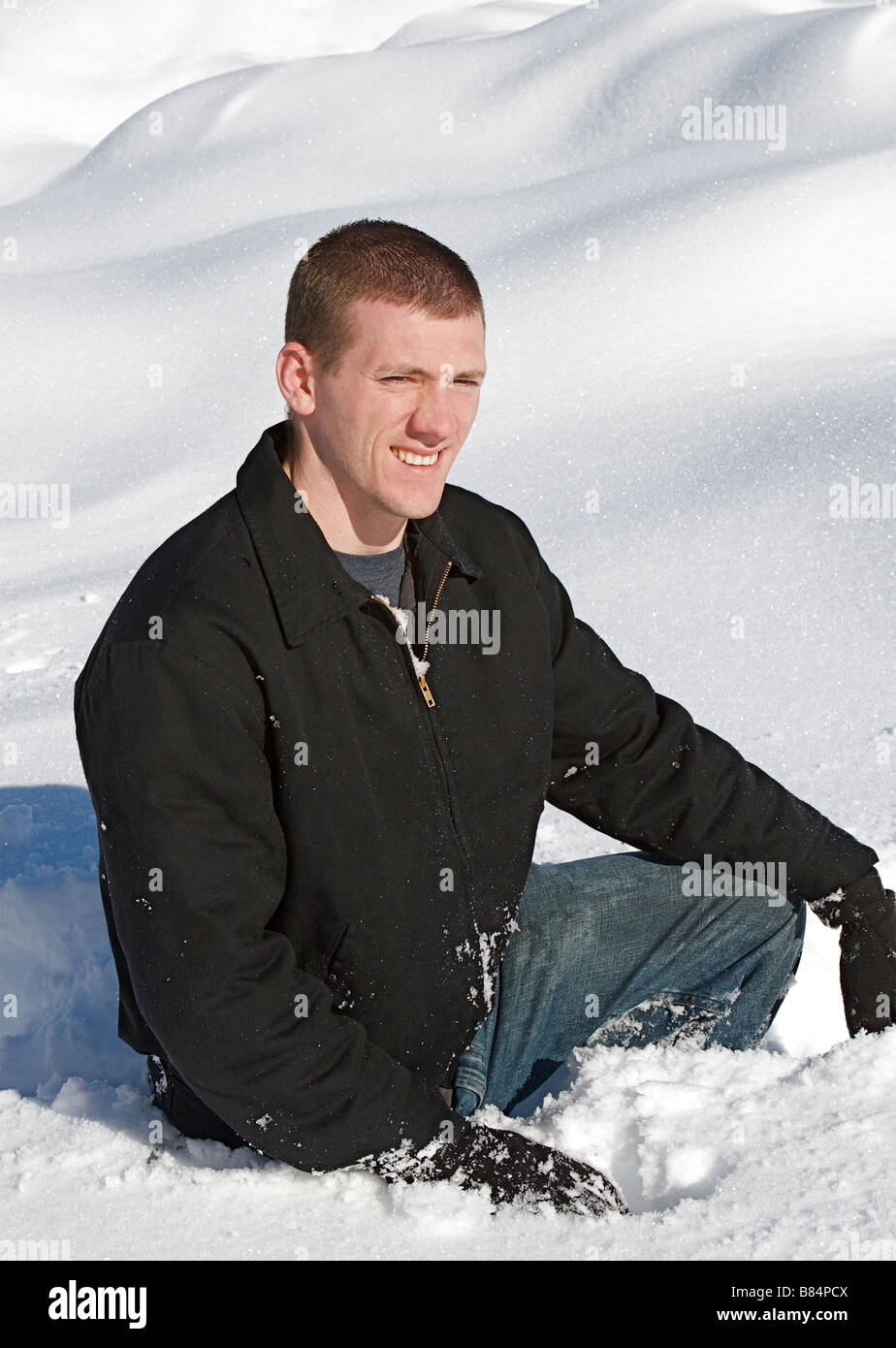 Young man enjoying a fresh snow fall Stock Photo - Alamy