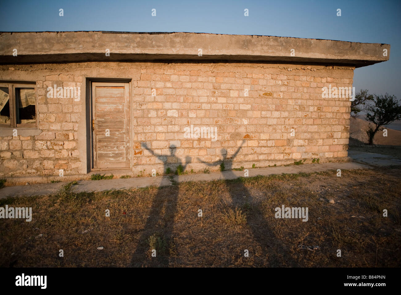 two shadows playing on a poor house Stock Photo - Alamy