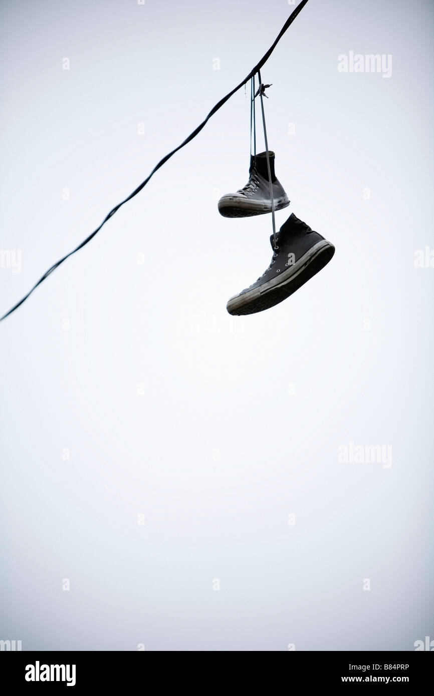 Shoes hanging from a line Stock Photo - Alamy