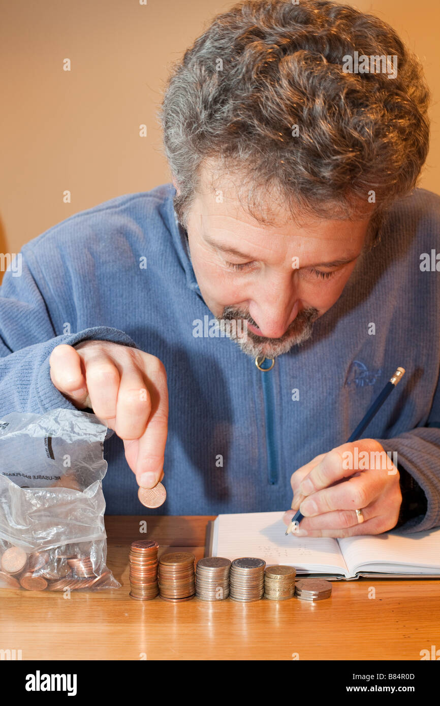 Money hoarding hi-res stock photography and images - Alamy