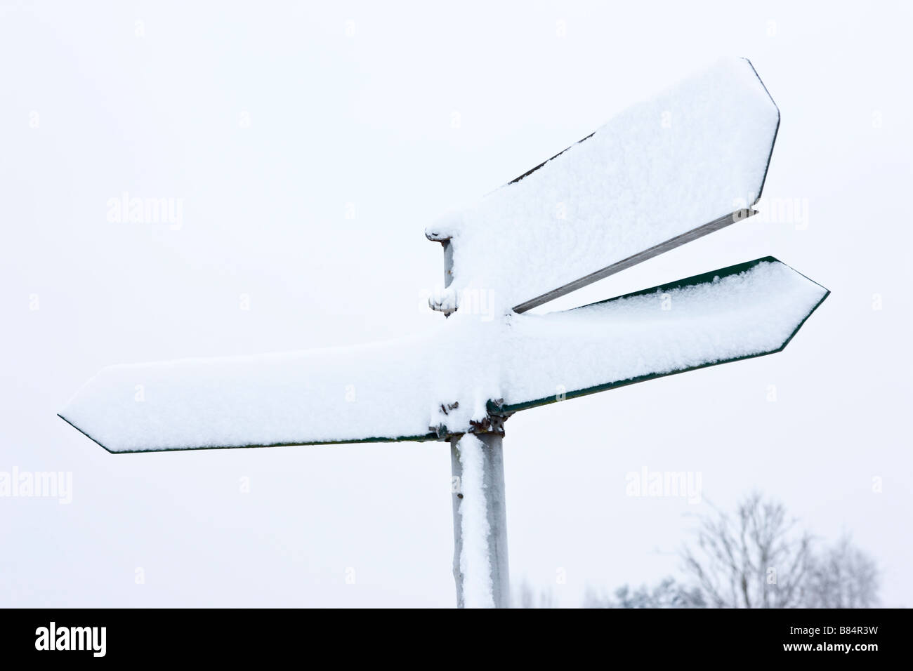 A snow covered signpost against a white sky Stock Photo - Alamy