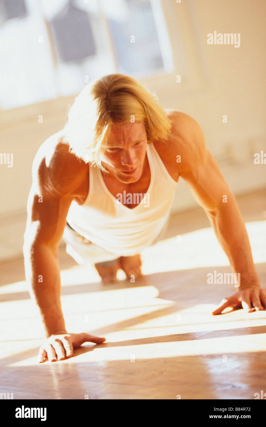 Young man preforming push up exercise in gym Stock Photo - Alamy