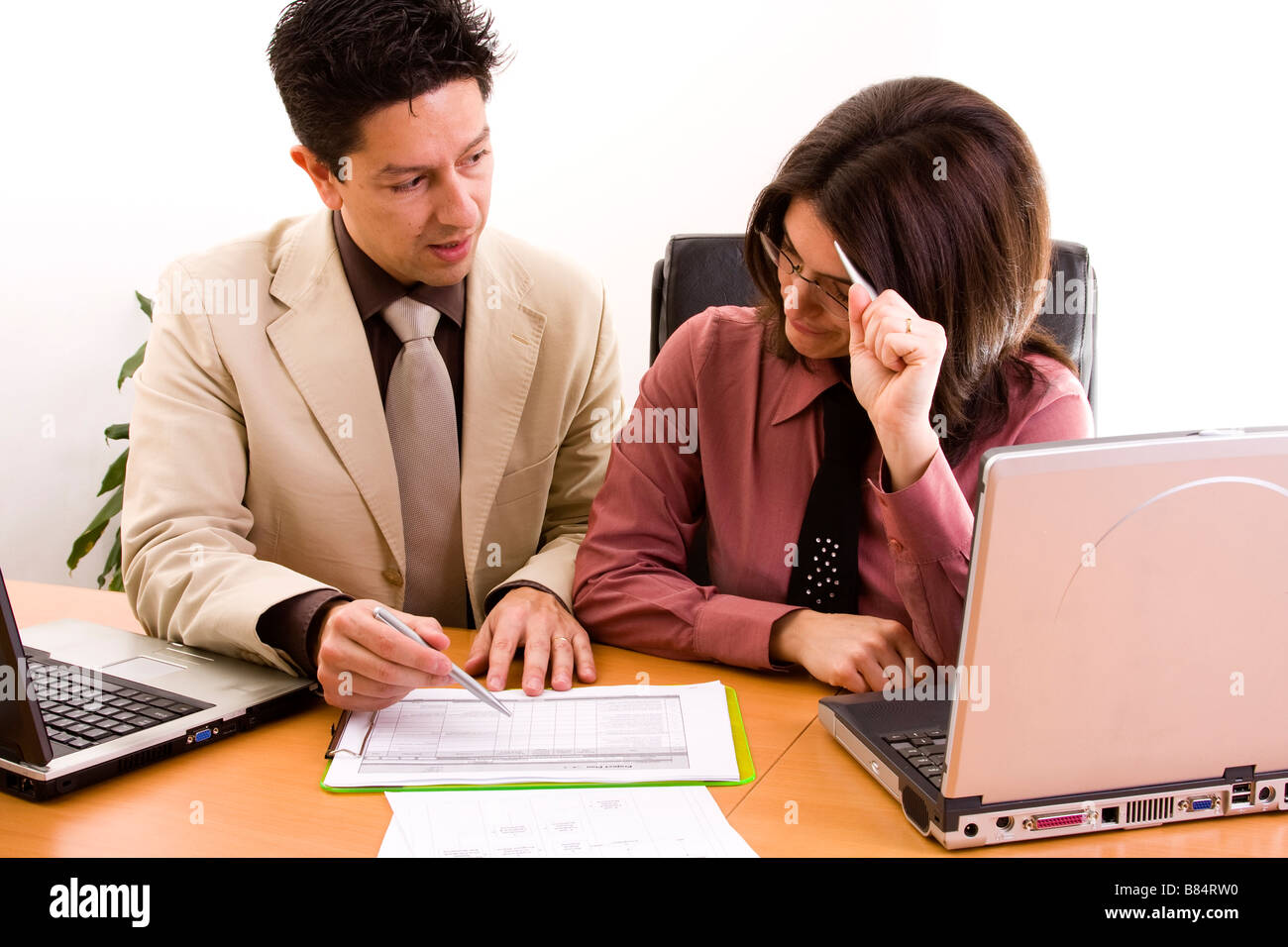business team reviewing some documents at the office Stock Photo - Alamy
