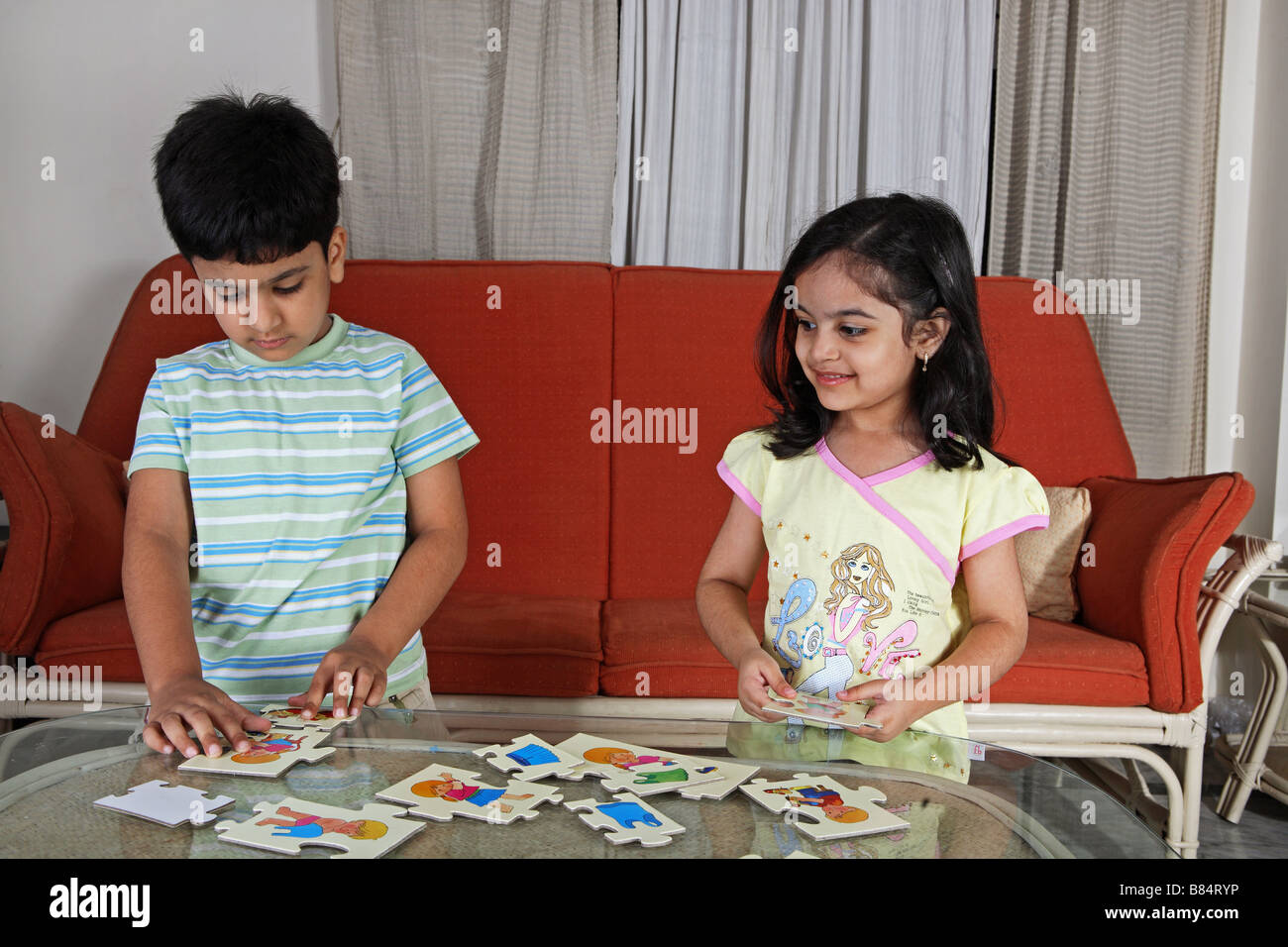 Young children solving a picture puzzle Stock Photo - Alamy