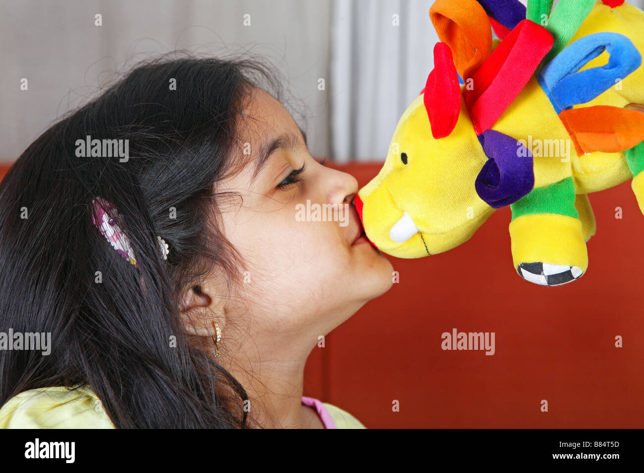 Young girl kissing a soft toy Stock Photo - Alamy