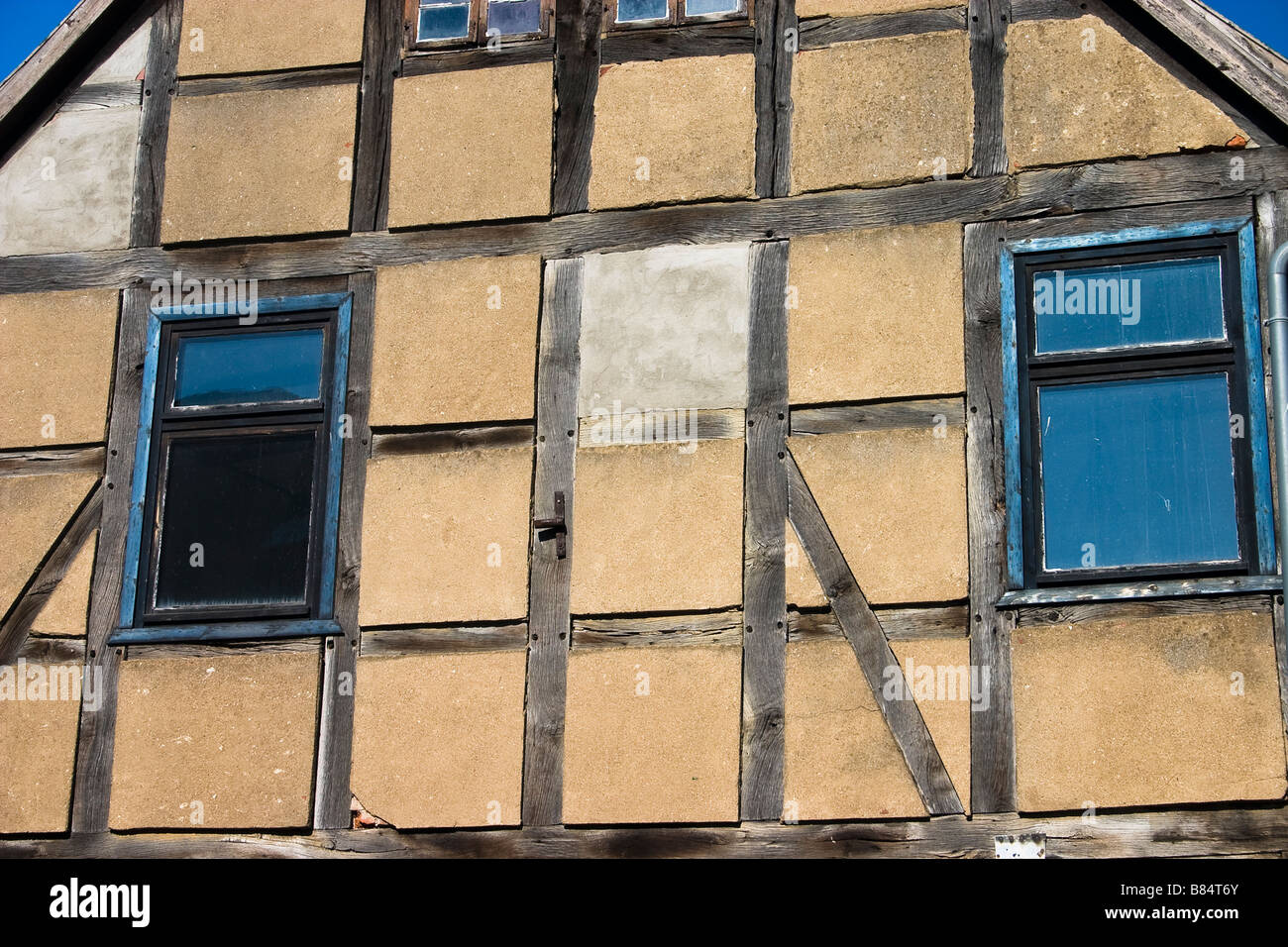 Facade of an old house with two windows Stock Photo - Alamy