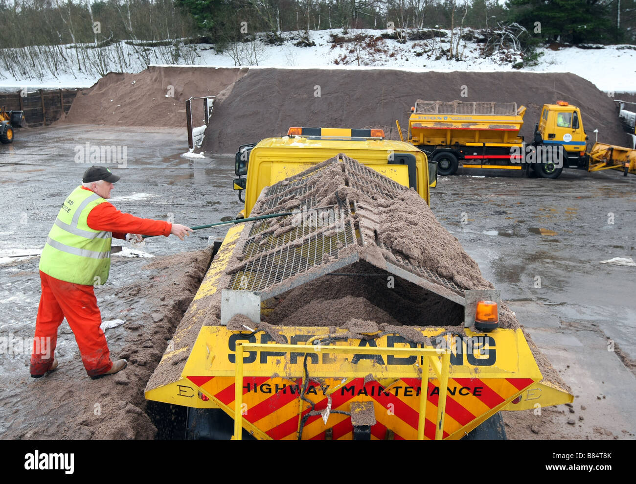 Gritters and snow ploughs being loaded with road grit at council roads ...