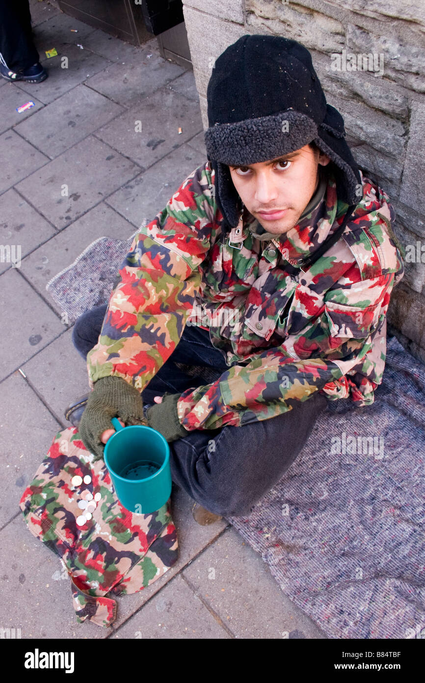 Young boy begging on the streets of Oxford Stock Photo - Alamy