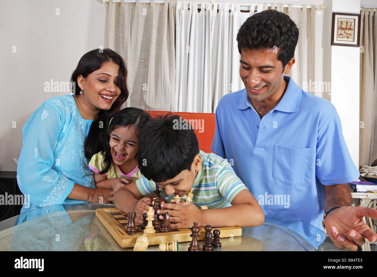 A family playing a game of chess Stock Photo - Alamy