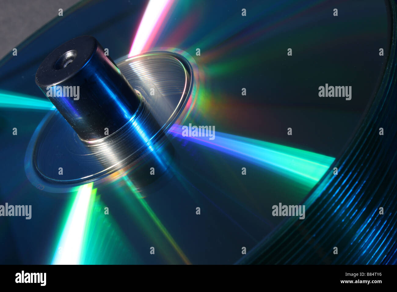 stack of CD's on a spindle lit with red and blue studio lighting Stock ...