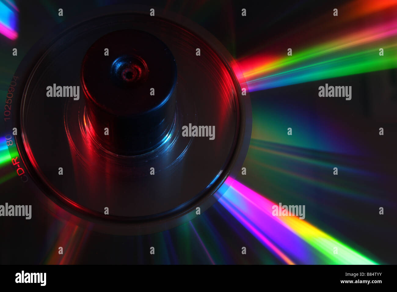 stack of CD's on a spindle lit with red and blue studio lighting Stock ...