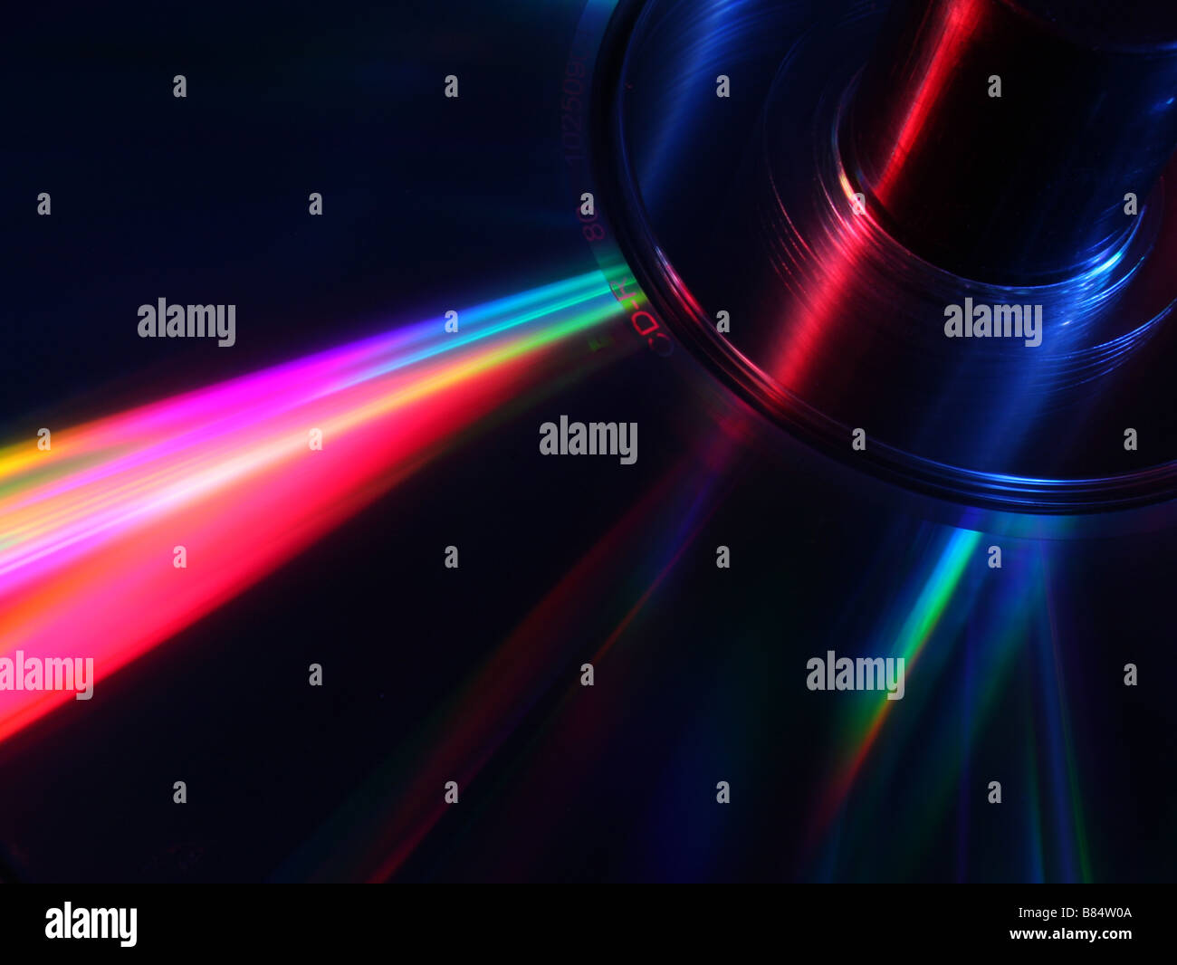 stack of CD's on a spindle lit with red and blue studio lighting Stock ...