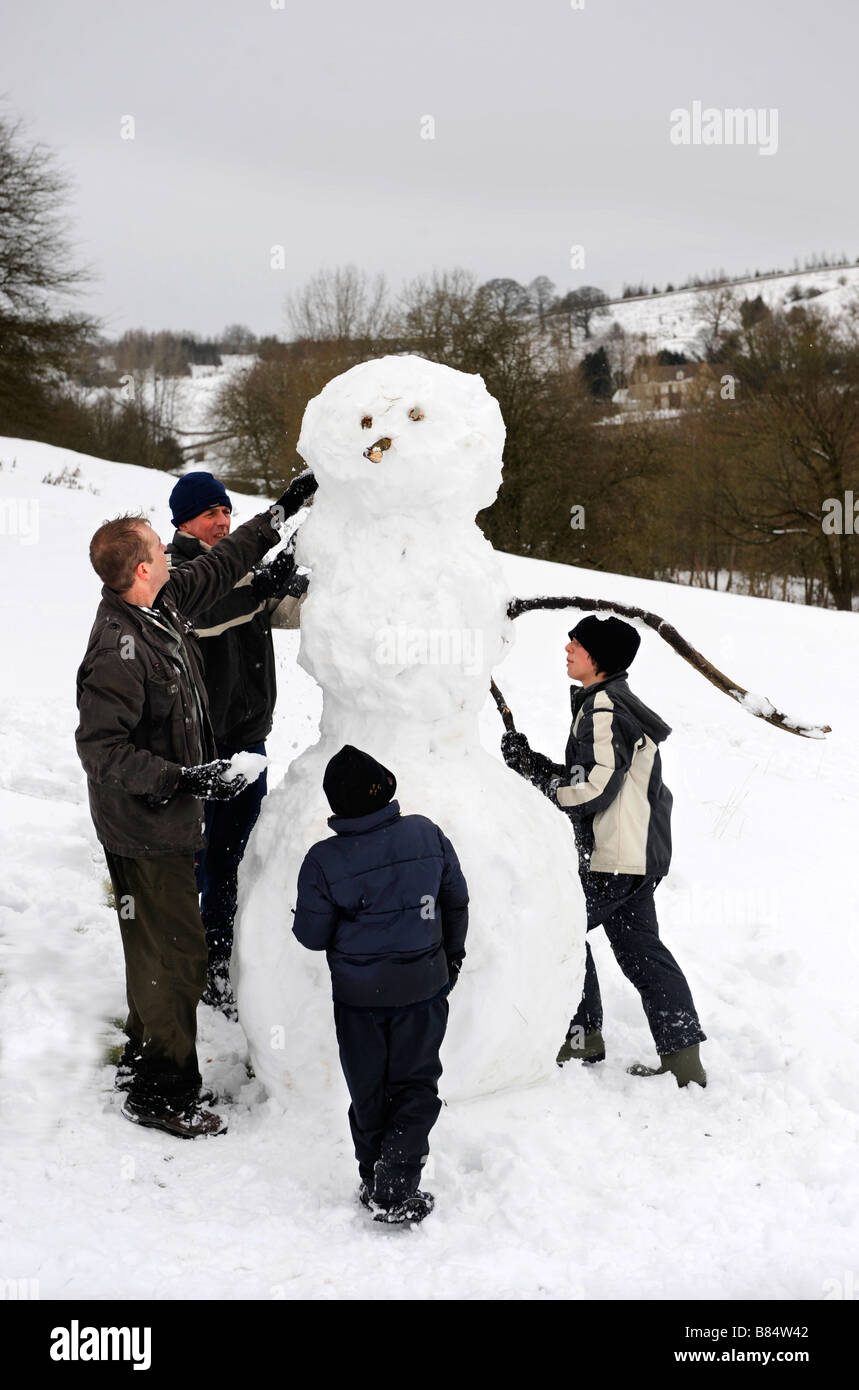 Children build a snowman hi-res stock photography and images - Alamy