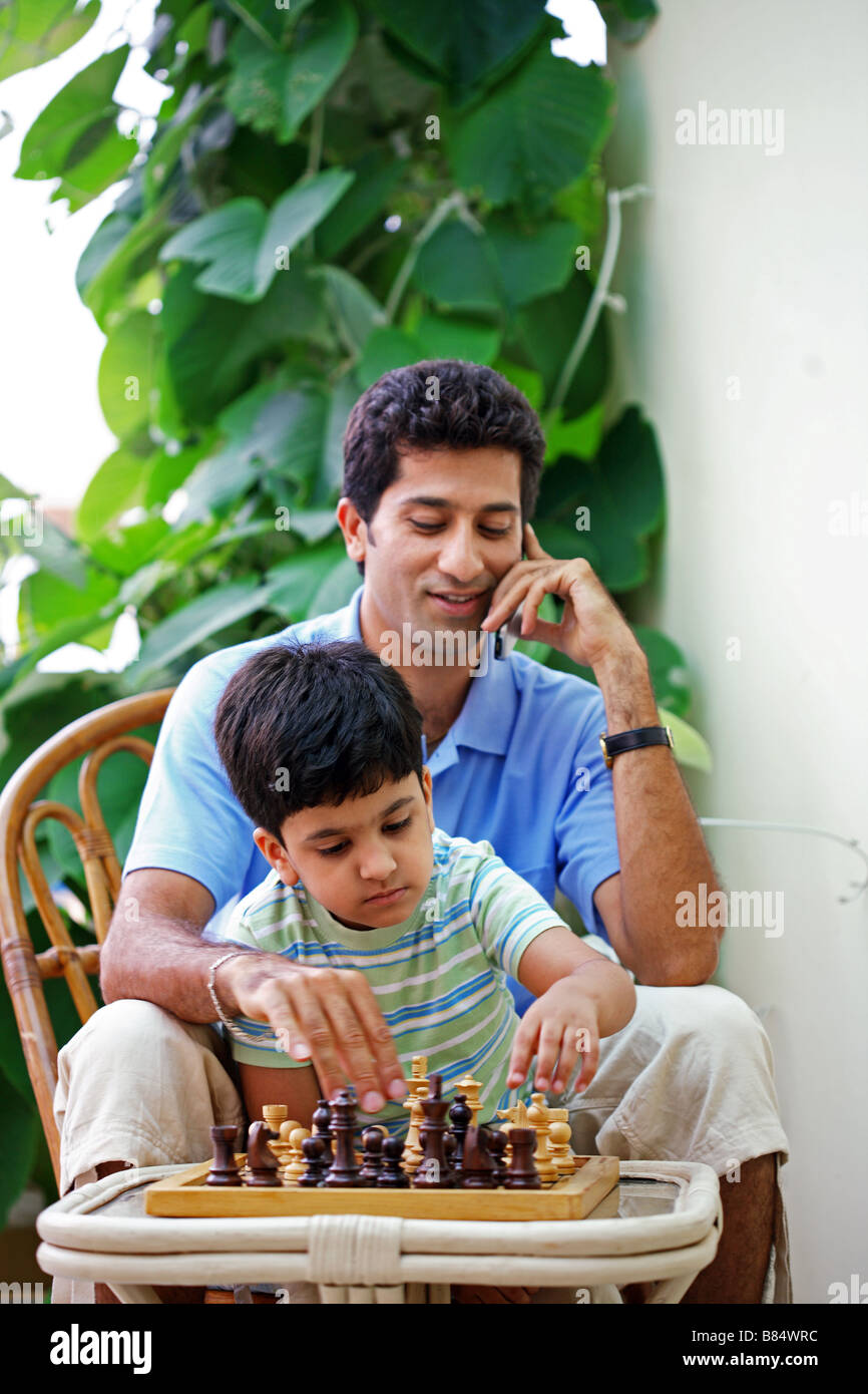 Indian father and son playing chess hi-res stock photography and images ...