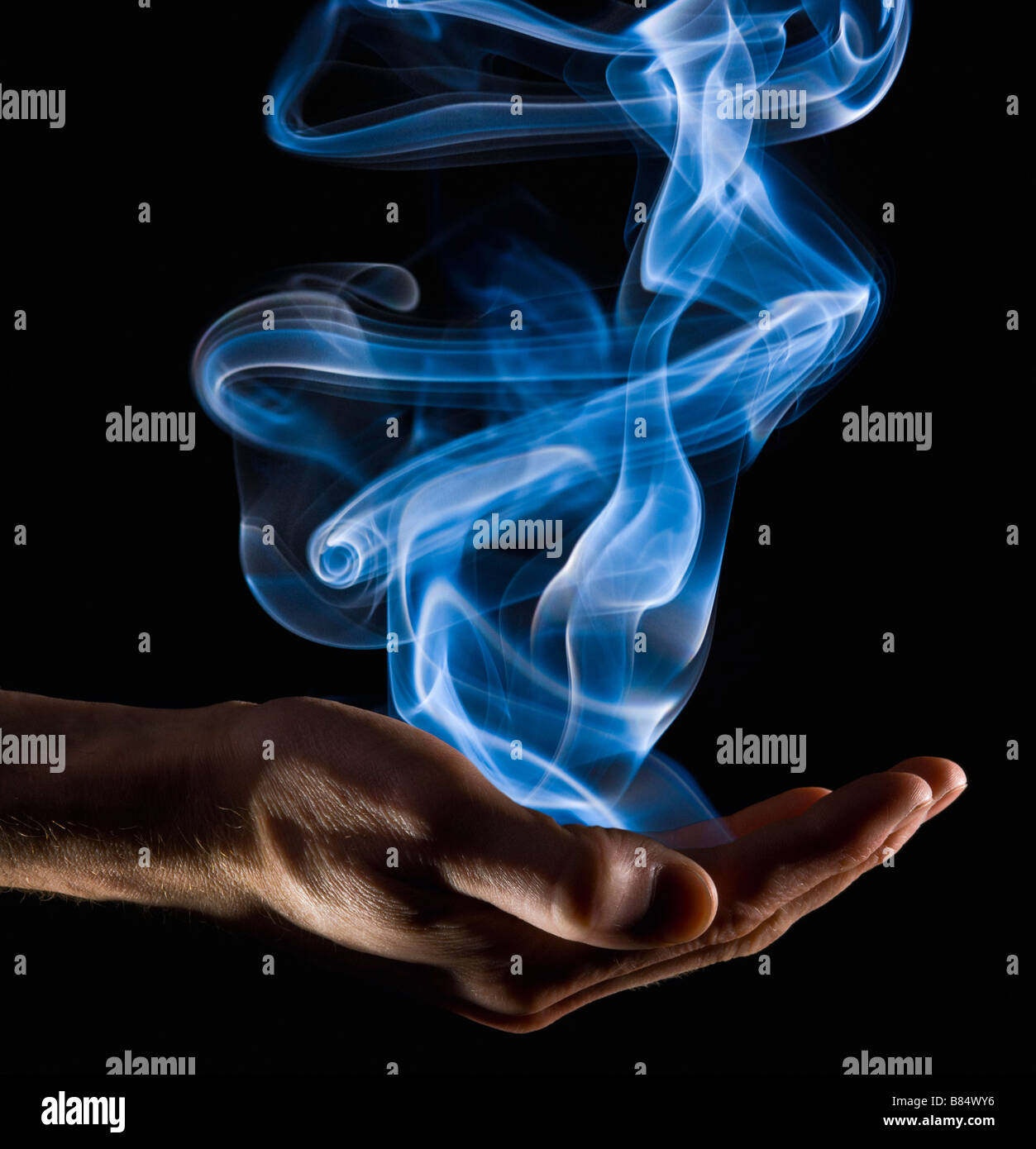 Smoke rising from a hand Stock Photo - Alamy