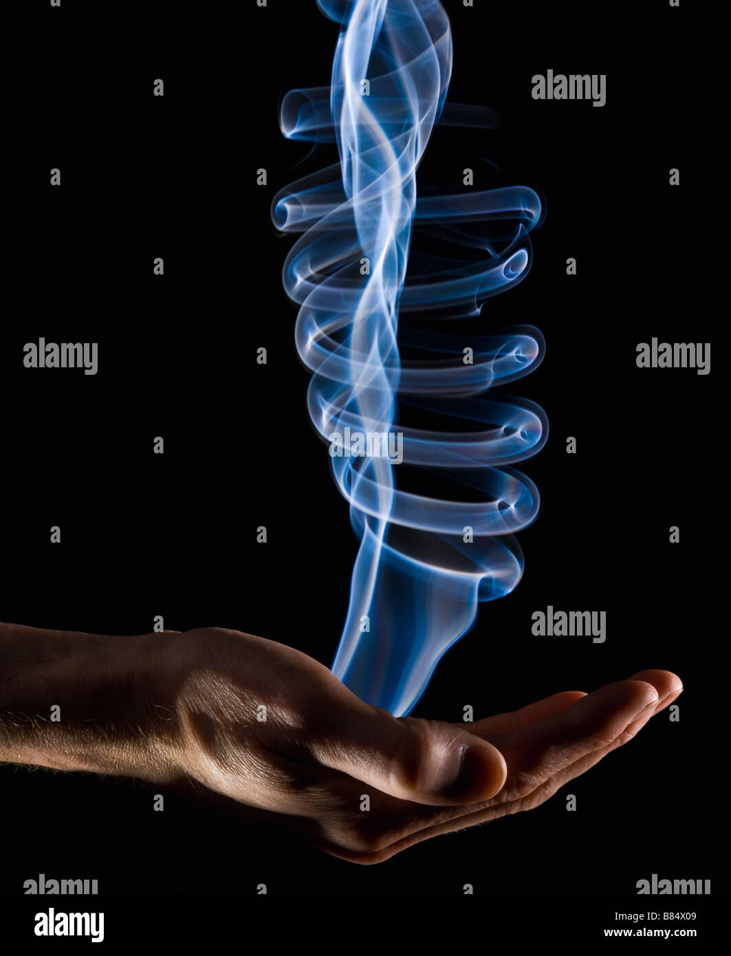 Smoke rising from a hand Stock Photo - Alamy