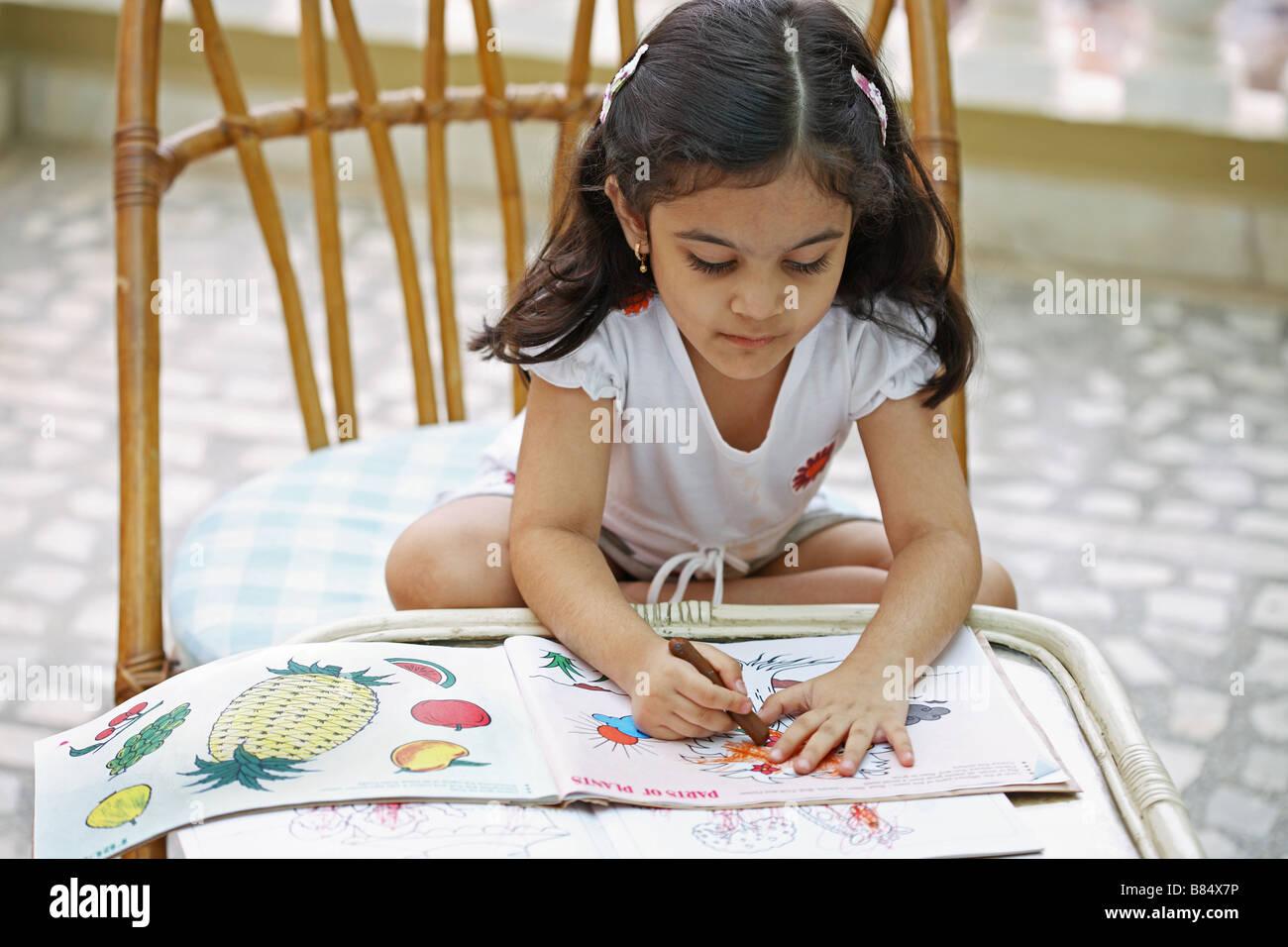 A young girl doing her home work Stock Photo - Alamy