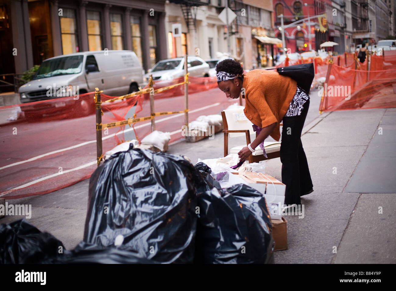 Woman going through garbage next to curb Manhattan New York New York ...