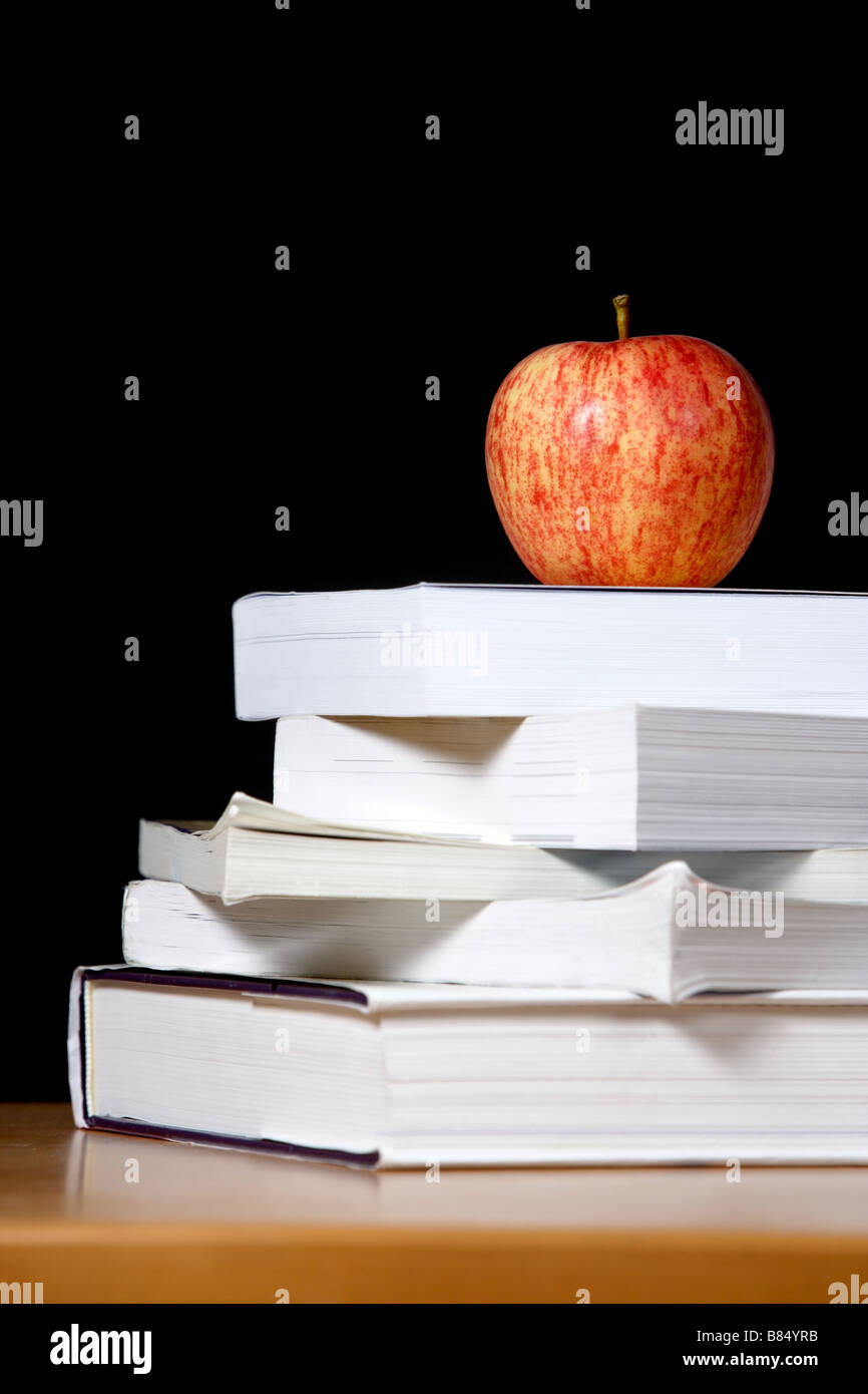 An apple on top of a stack of books Stock Photo - Alamy