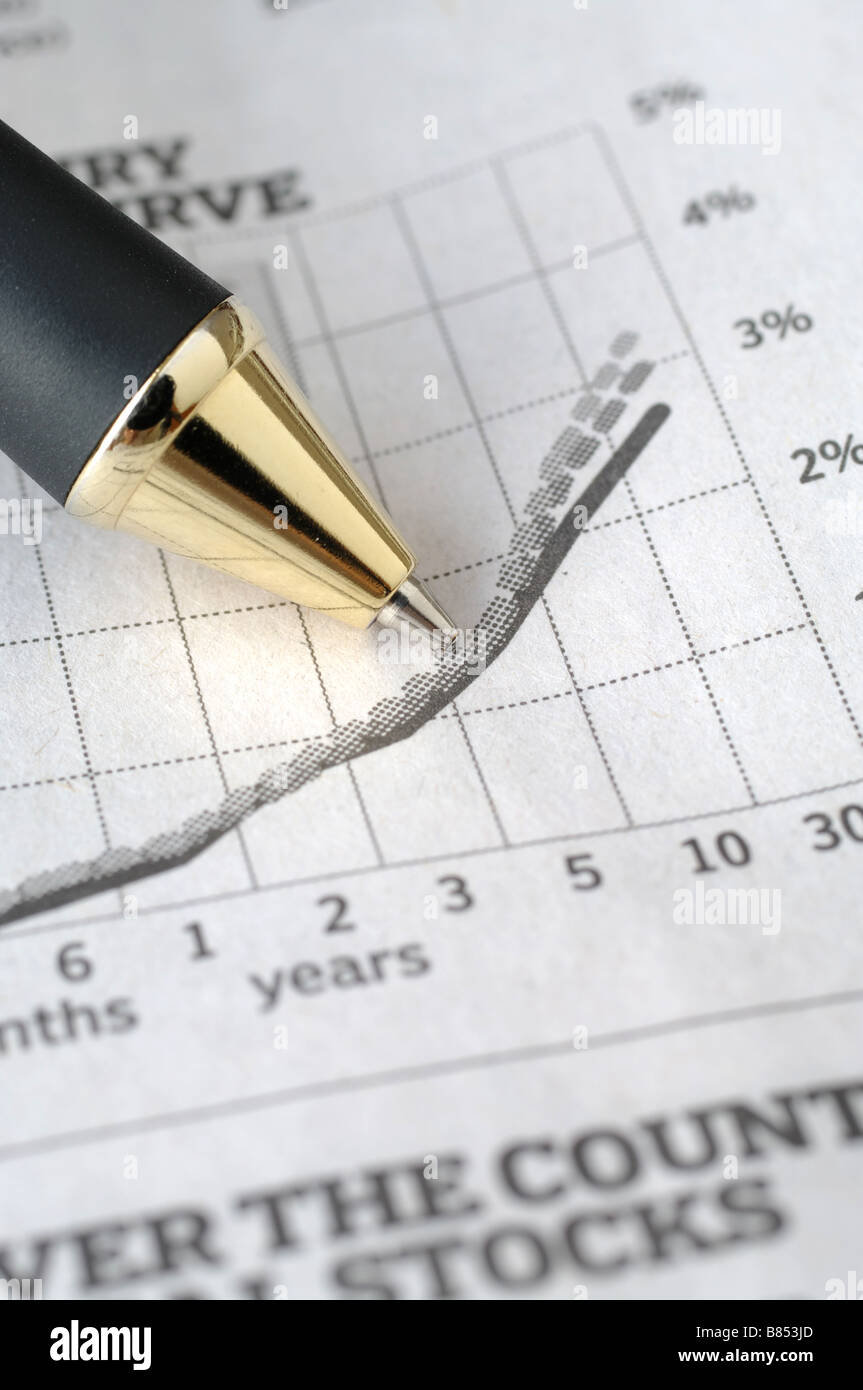 Pen pointing at a financial chart in newspaper Stock Photo - Alamy