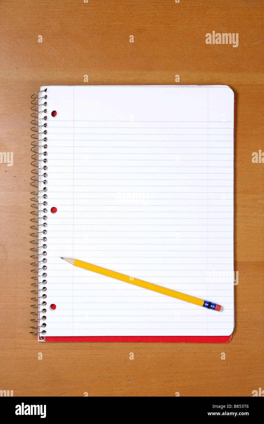 A note book and pencil on a desk in an office Stock Photo - Alamy