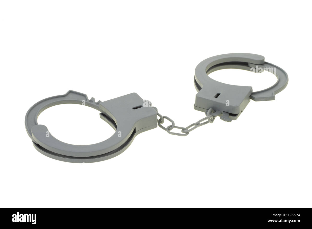 Toy plastic handcuff on white background Stock Photo - Alamy