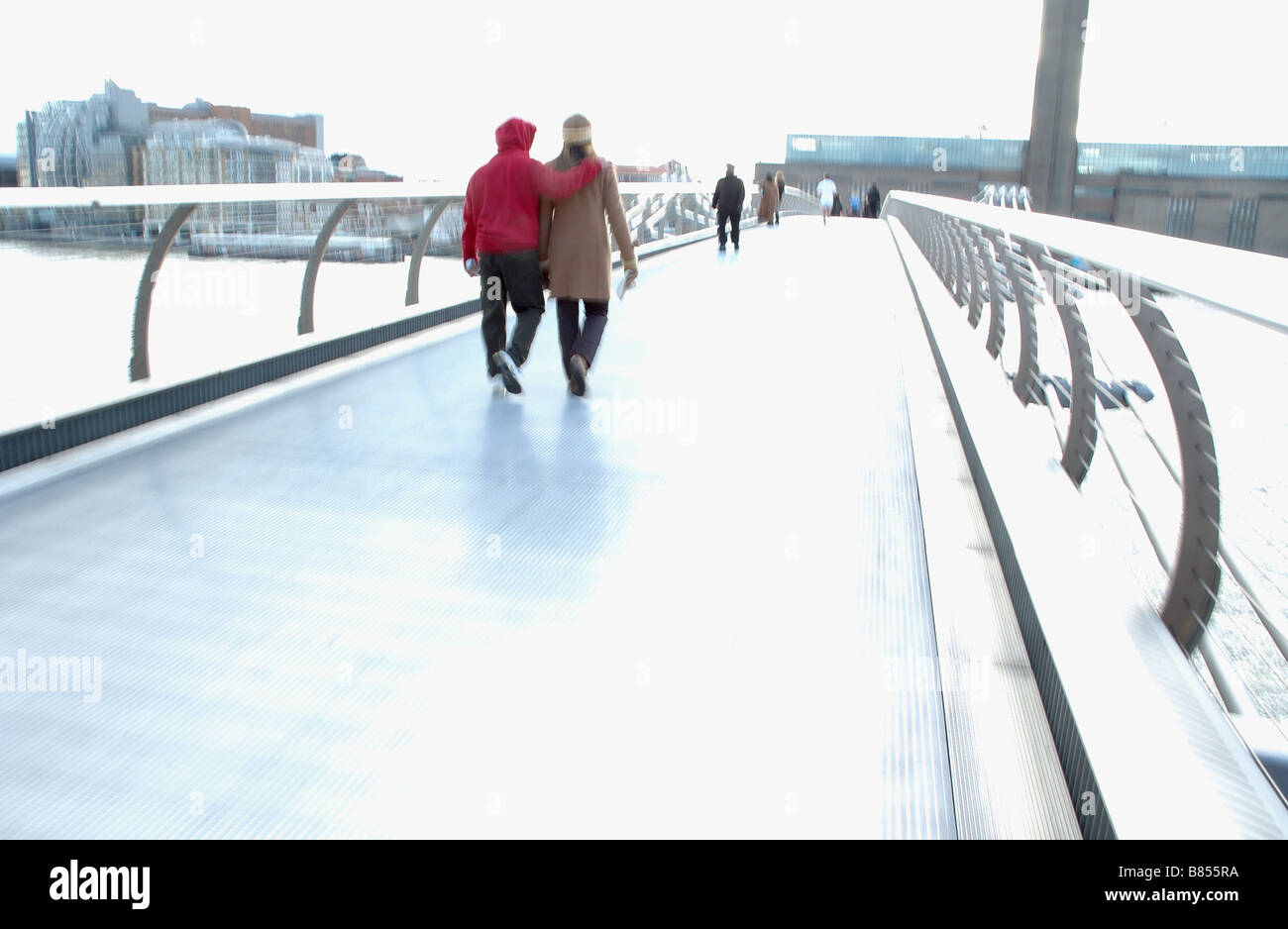 Tourists walking over Millennium Bridge with Tate Modern in background ...