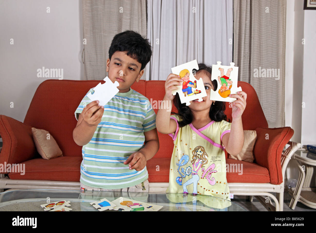 Young children solving a picture puzzle Stock Photo - Alamy