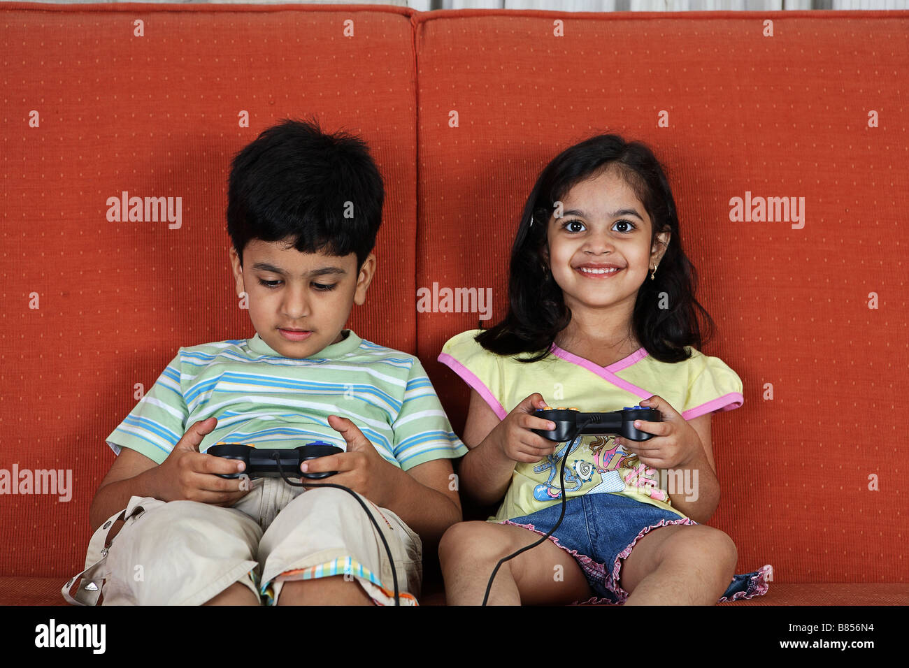 Young children playing video games in a playful mood Stock Photo - Alamy