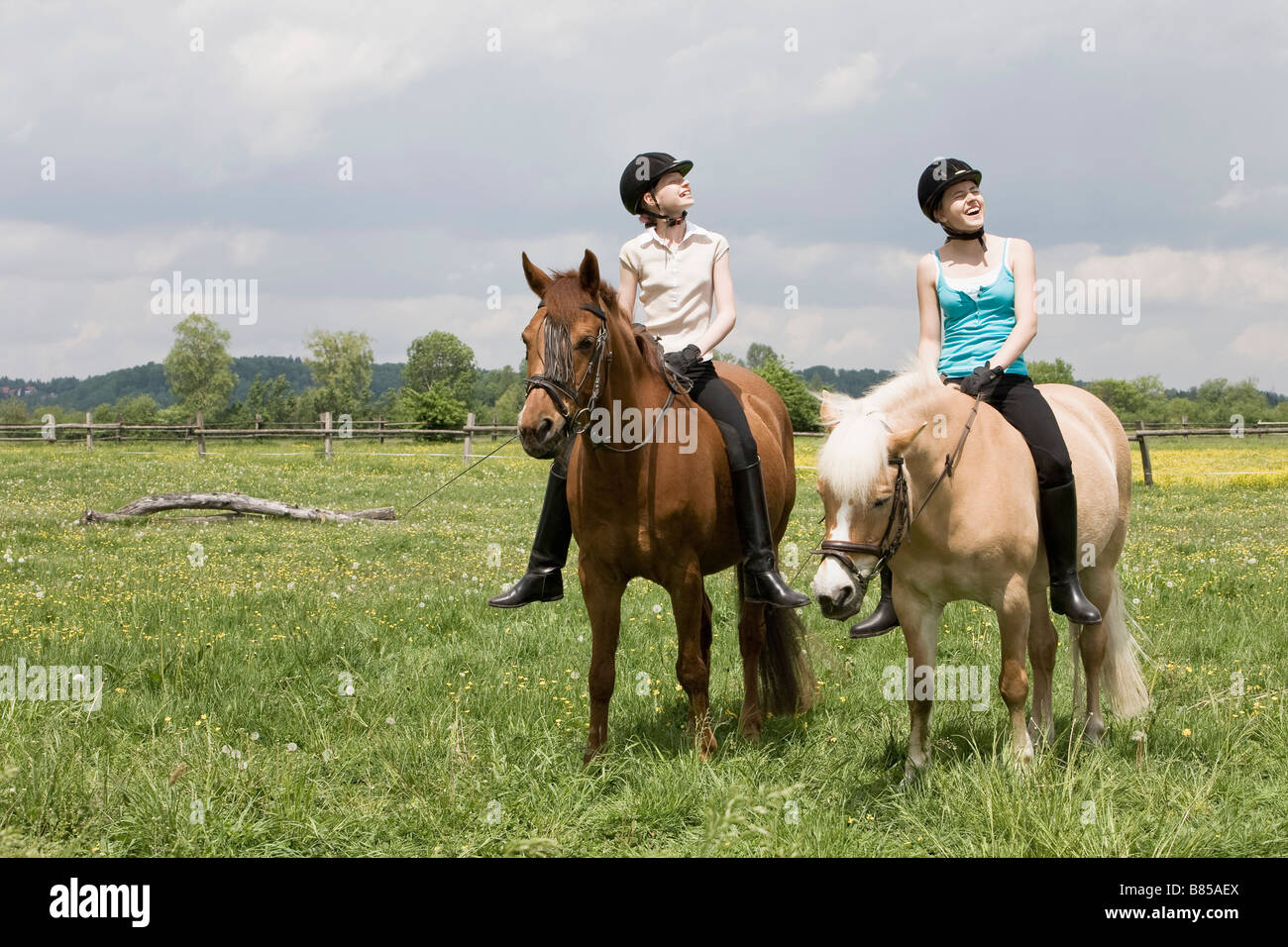 two girls doing horseback riding Stock Photo - Alamy