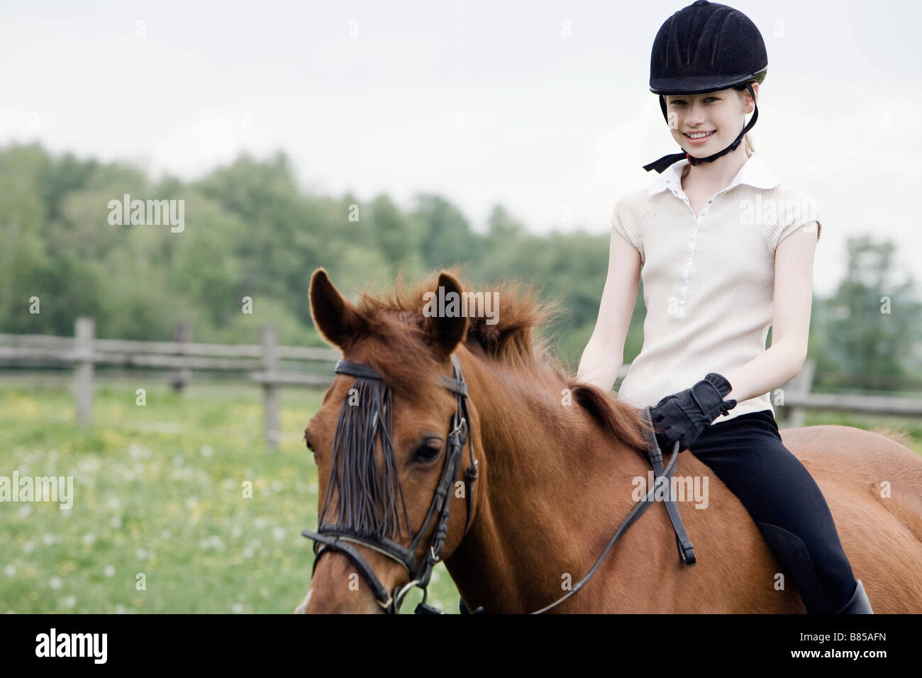 portrait of young girl doing horseback riding Stock Photo - Alamy