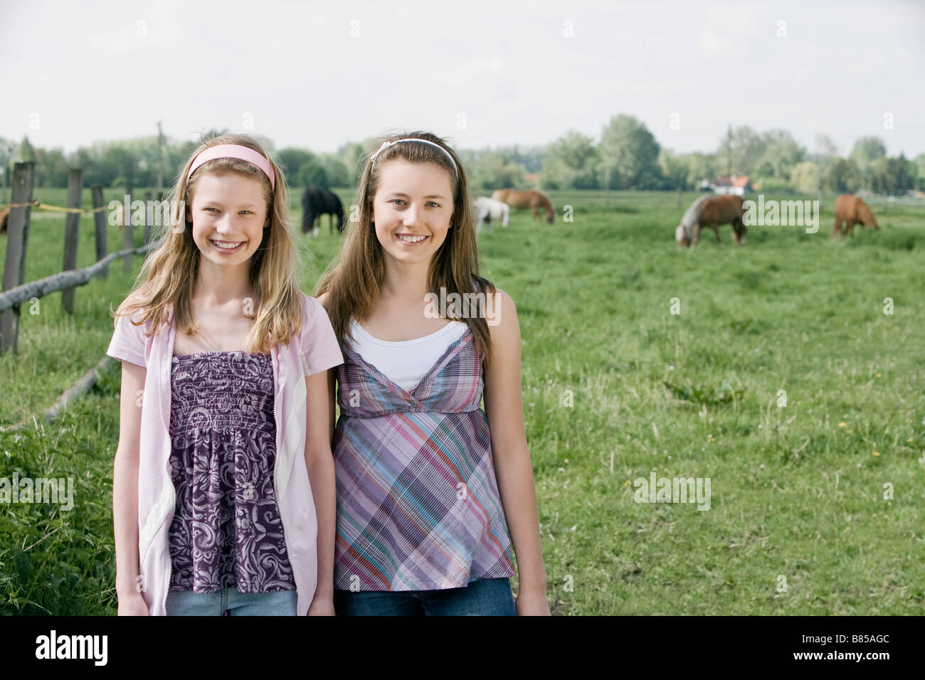 portrait of two girls on horse ranch Stock Photo - Alamy