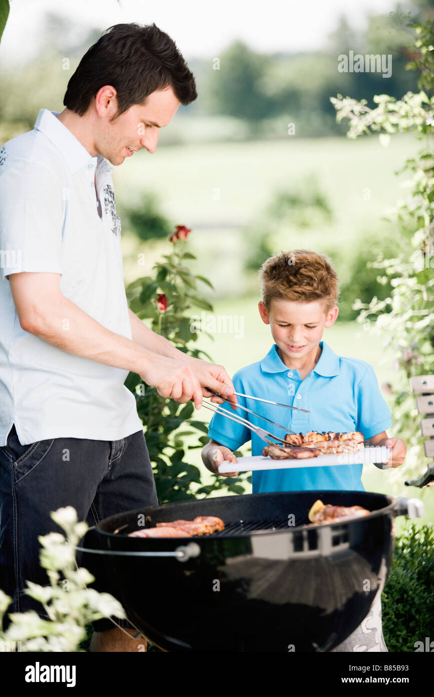 father and son grilling together at barbecue Stock Photo - Alamy