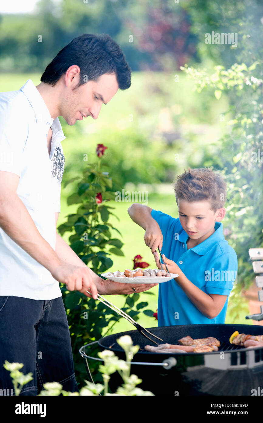 father and son grilling together at barbecue Stock Photo - Alamy