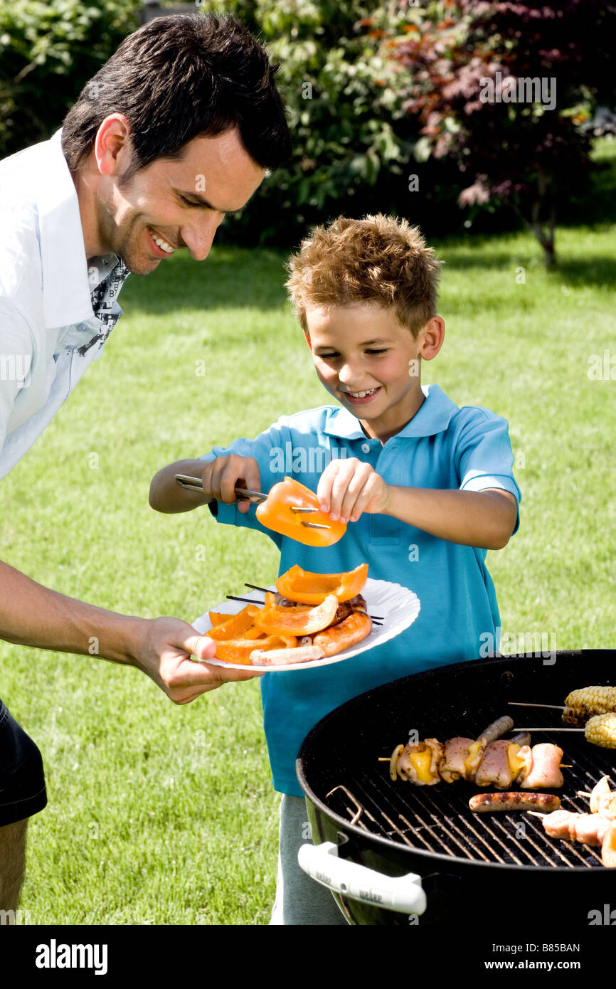 father and son grilling together at barbecue Stock Photo - Alamy