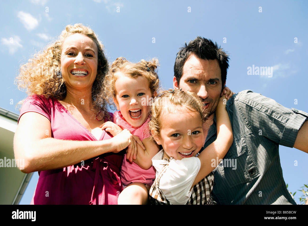 low angle portrait of family with two children Stock Photo - Alamy