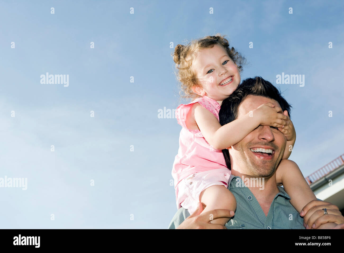 portrait of father carrying little girl on his shoulders Stock Photo - Alamy