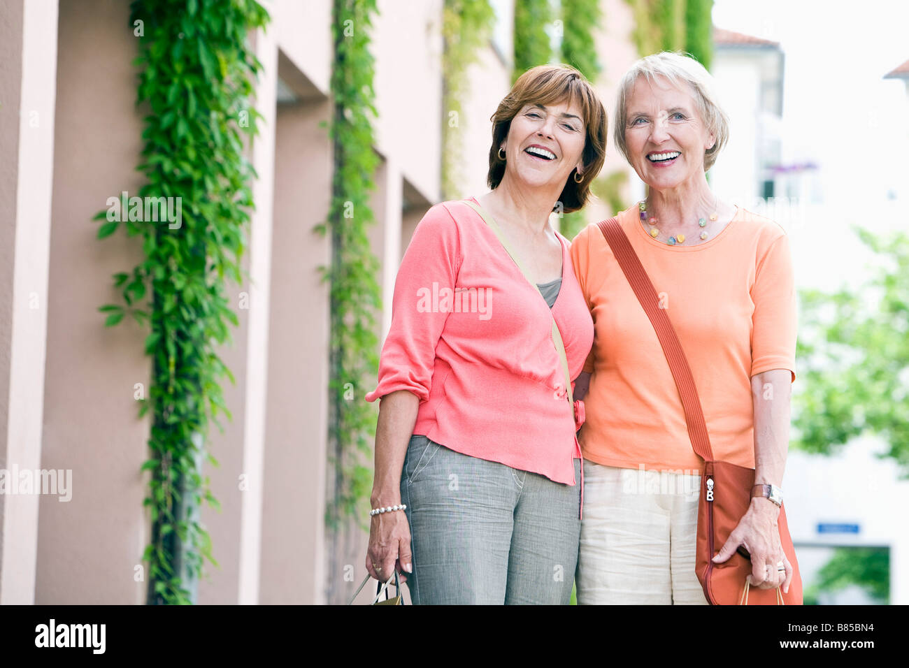 portrait of two senior women with shopping bags Stock Photo - Alamy